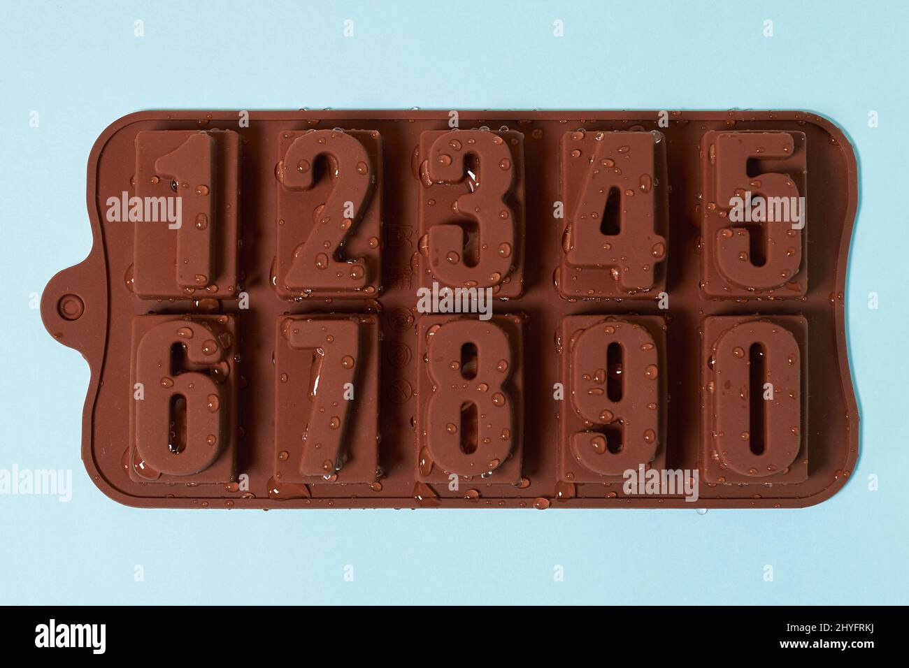 Brown silicone ice mold, numbers on a blue background Stock Photo - Alamy