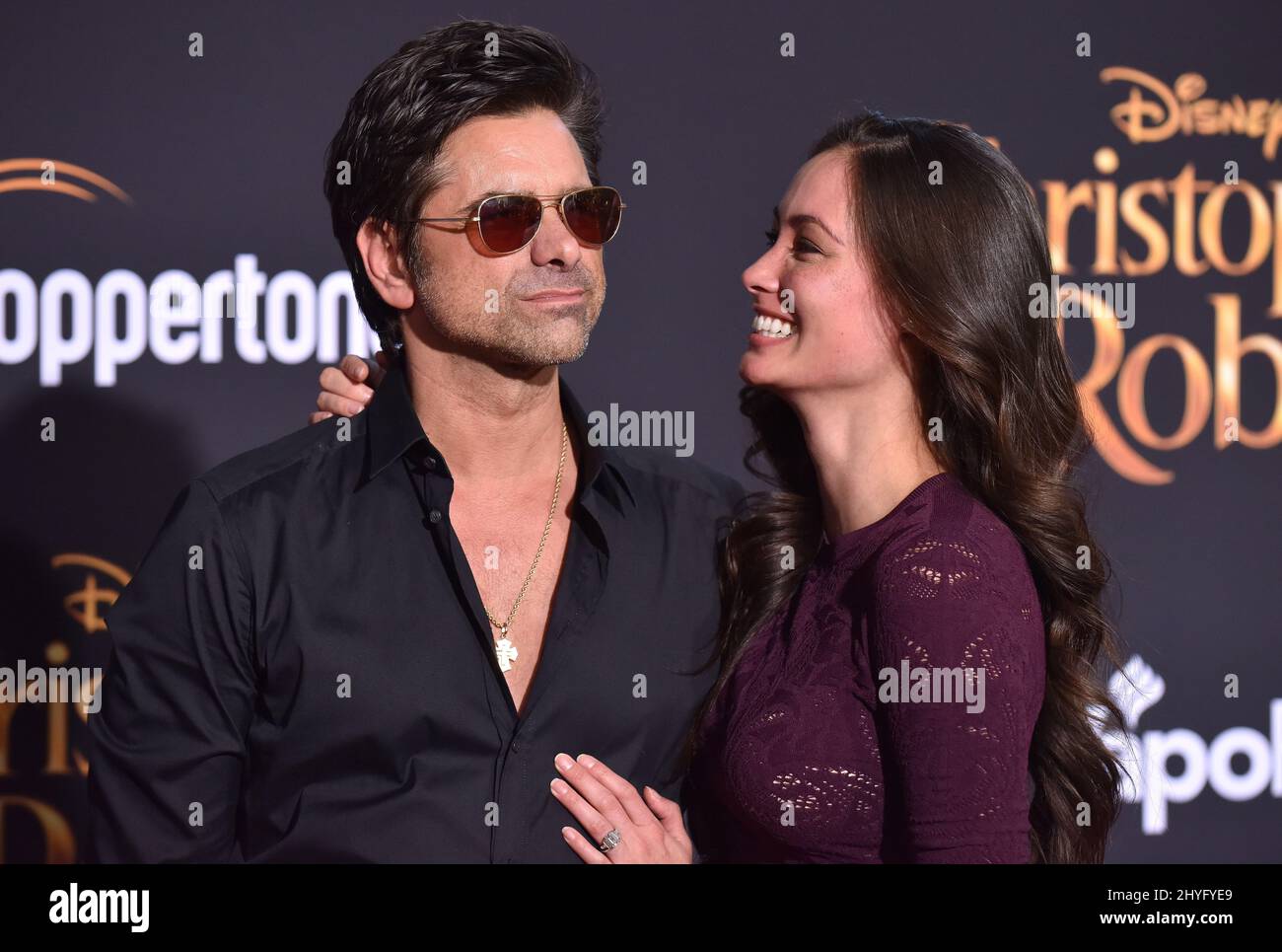 John Stamos and Caitlin McHugh attending the premiere of Christopher ...