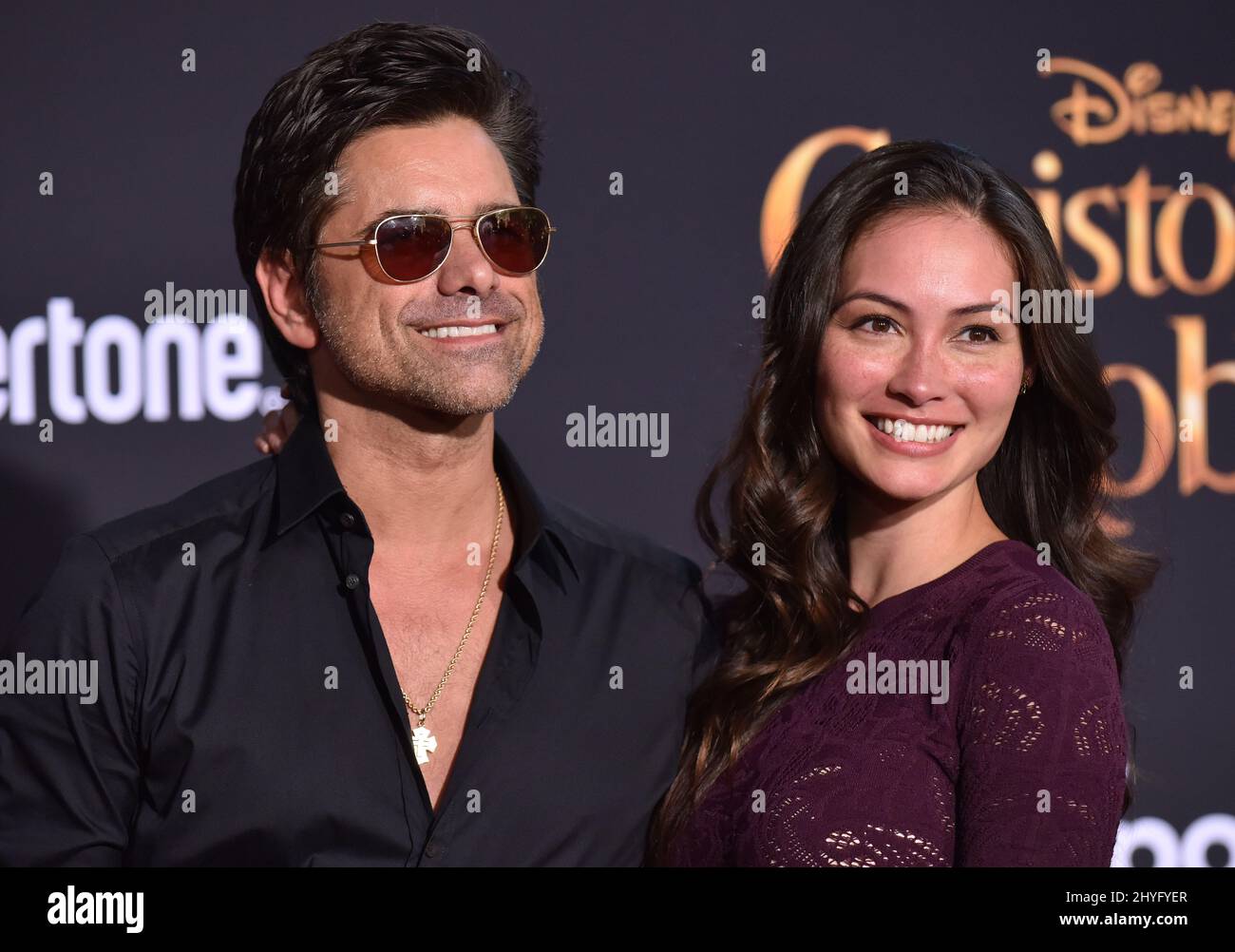 John Stamos and Caitlin McHugh attending the premiere of Christopher ...