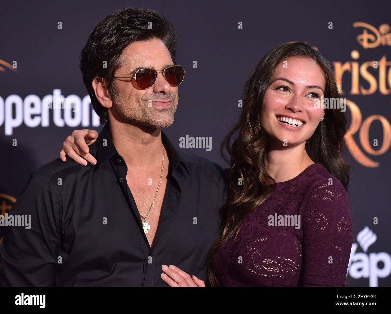 John Stamos and Caitlin McHugh attending the premiere of Christopher ...