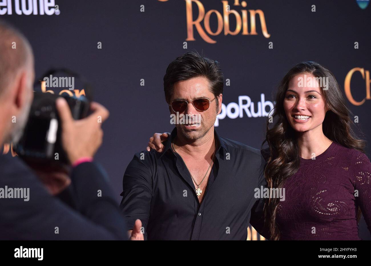 John Stamos and Caitlin McHugh attending the premiere of Christopher Robin in Los Angeles ...