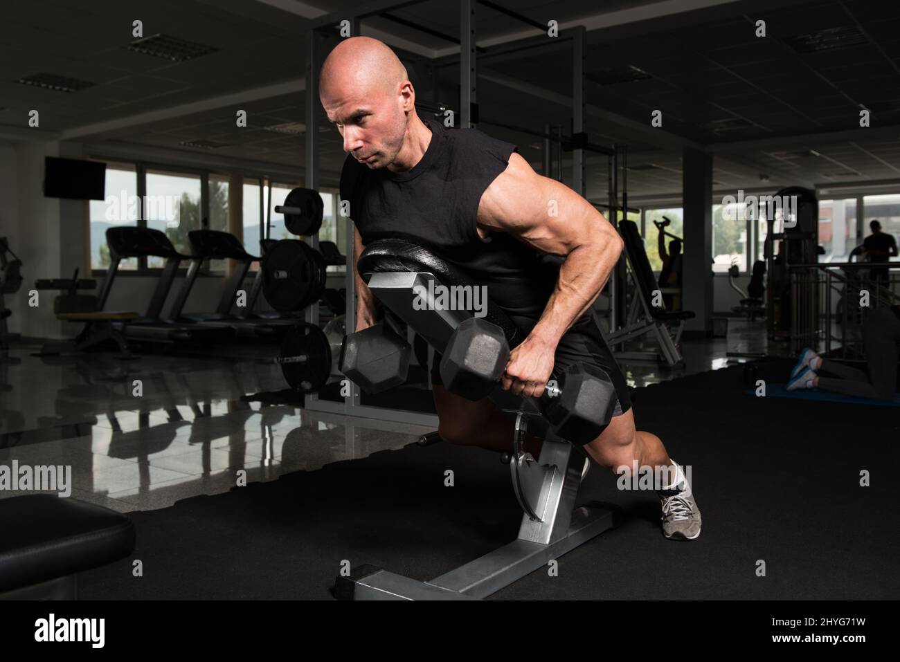 Serious Bodybuilder Doing Heavy Weight Exercise For Trapezius or Back ...