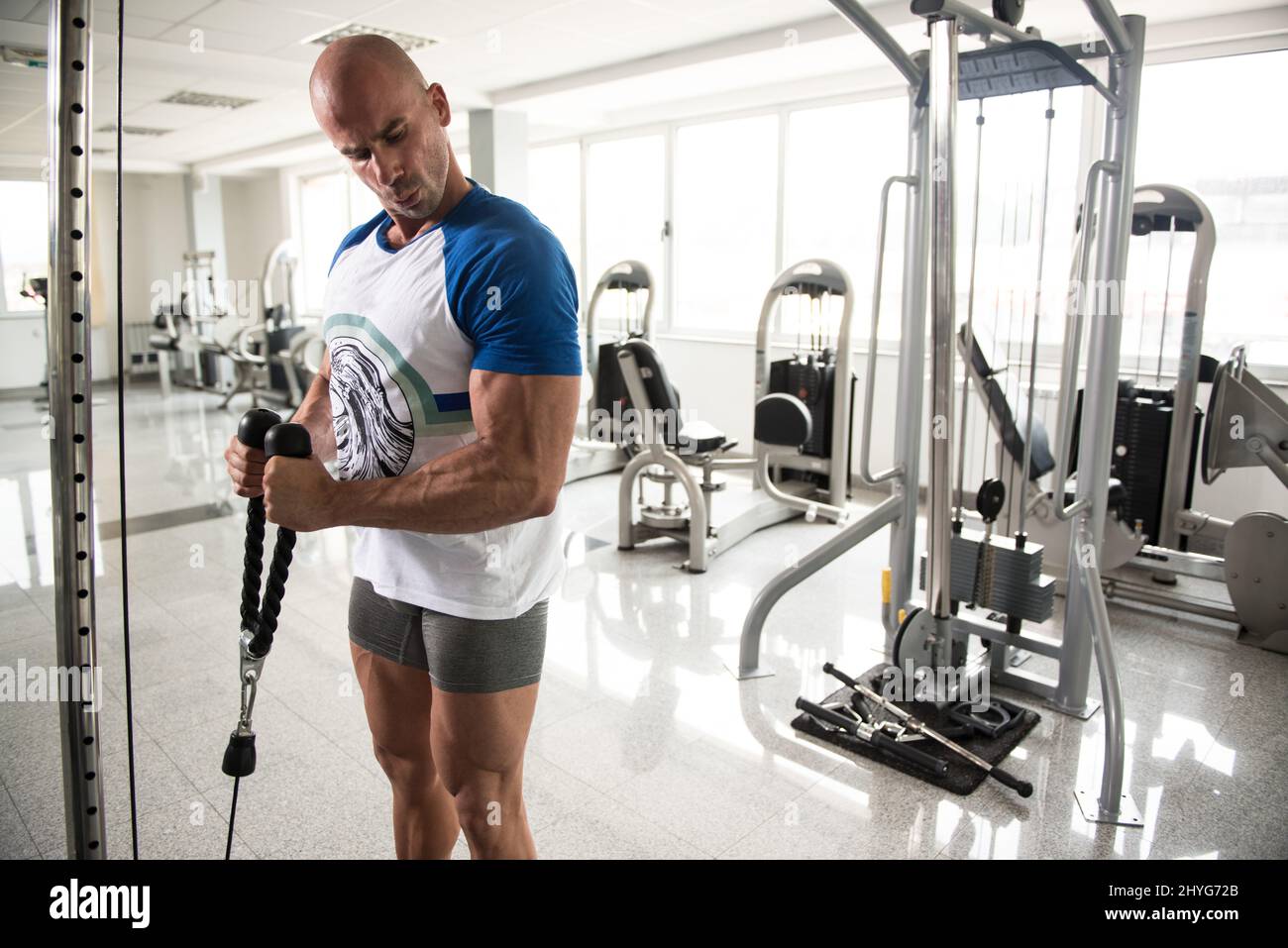 Young Muscular Fitness Bodybuilder Doing Heavy Weight Exercise For ...
