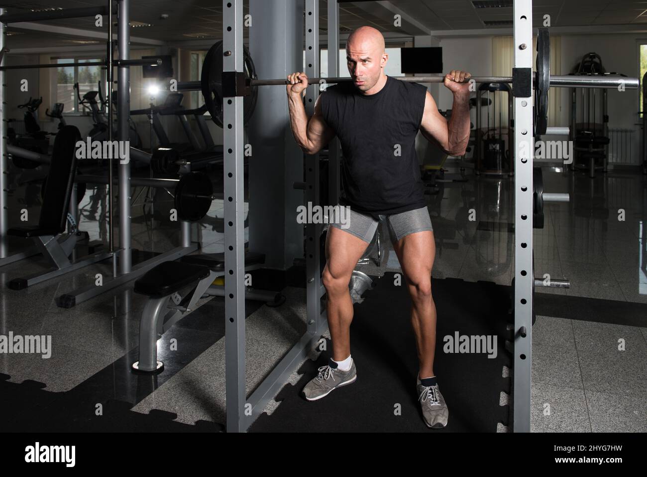 Man Working Out Legs With Barbell In A Gym - Front Squat Exercise Stock ...