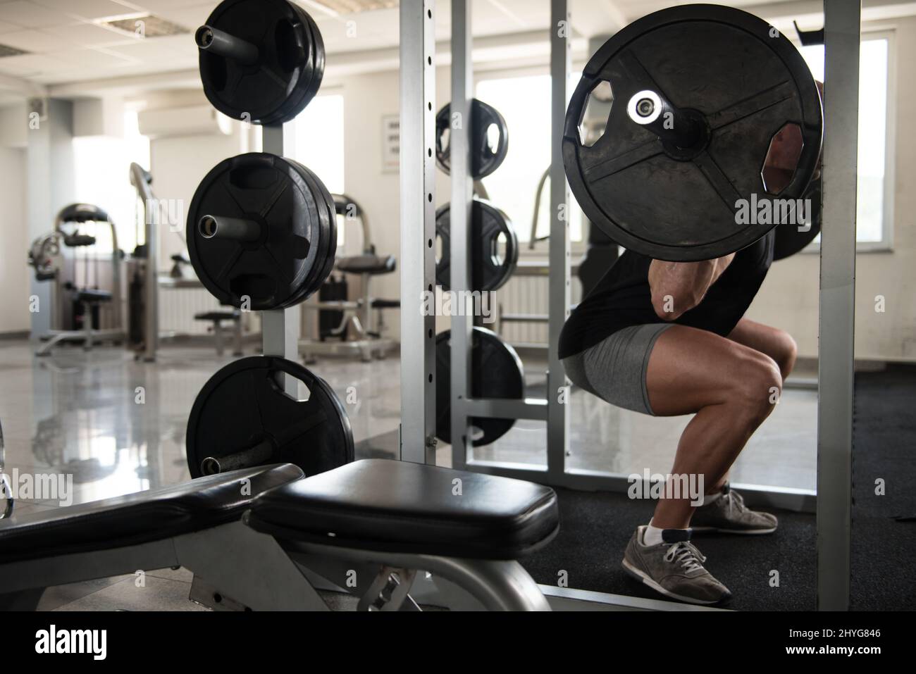 Man Working Out Legs With Barbell In A Gym - Front Squat Exercise Stock ...