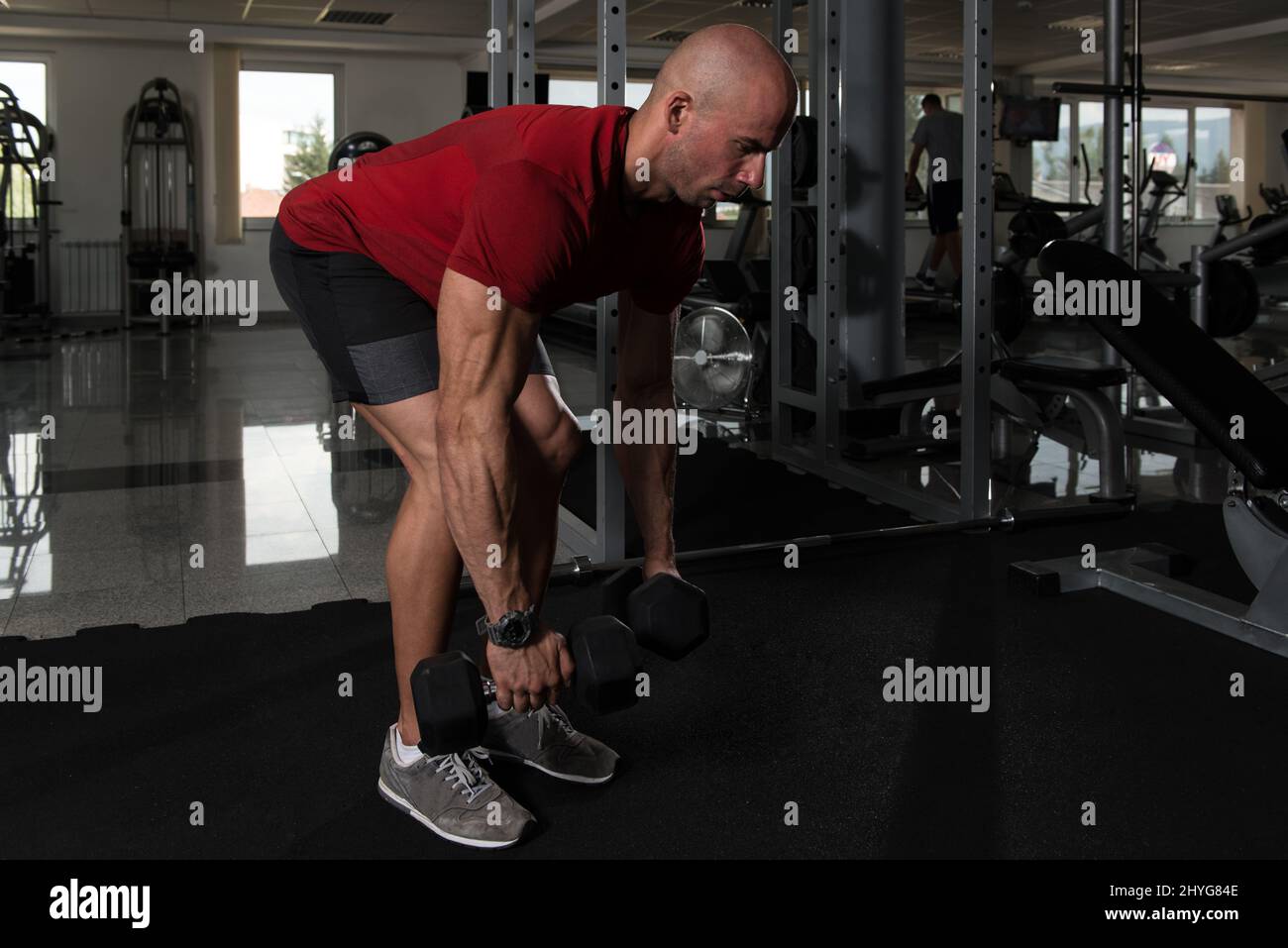 Serious Bodybuilder Doing Heavy Weight Exercise For Trapezius or Back ...