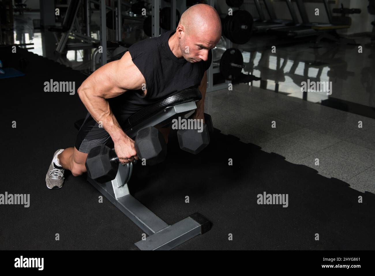 Serious Bodybuilder Doing Heavy Weight Exercise For Trapezius or Back ...