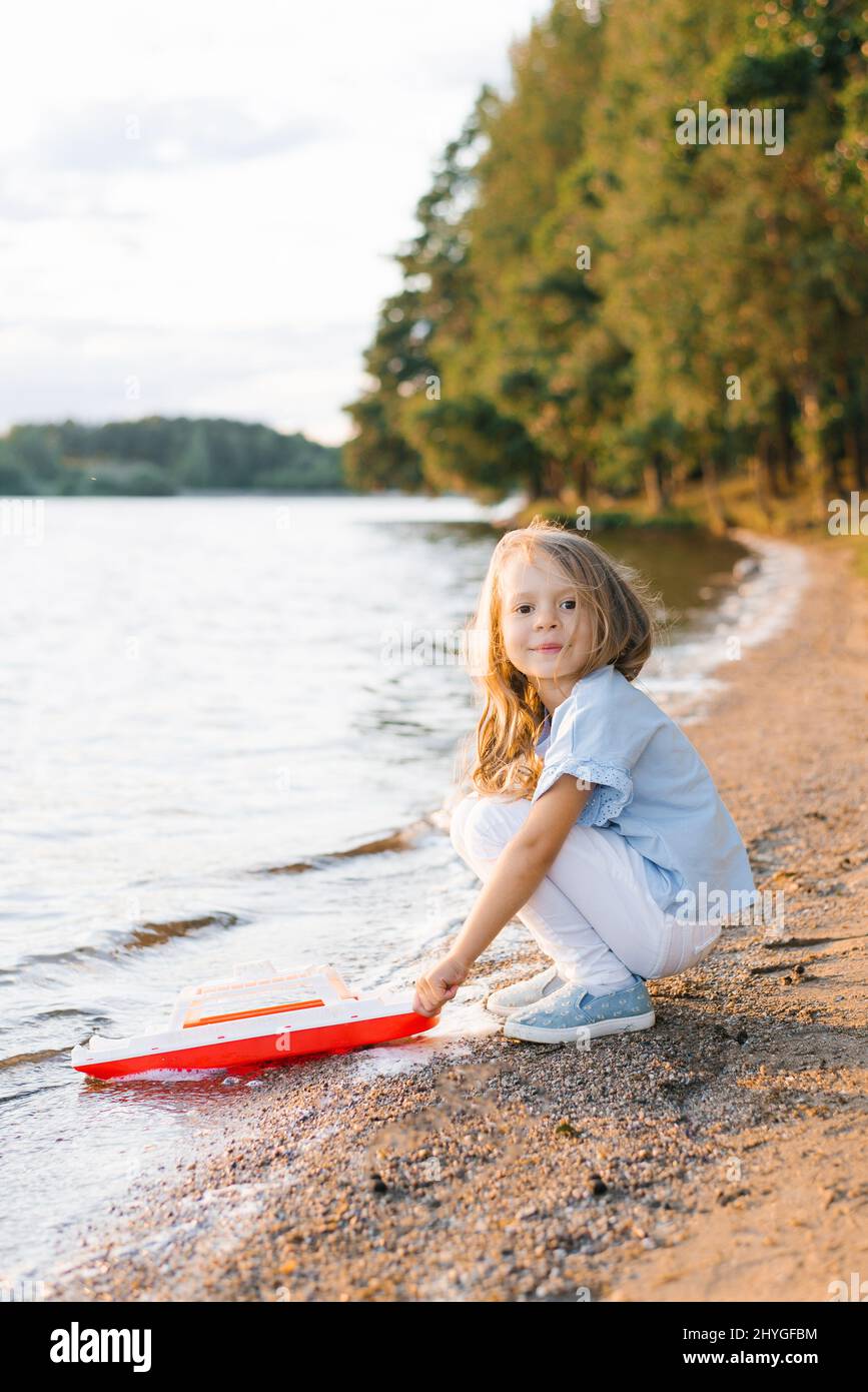 Girl with a toy boat hi-res stock photography and images - Alamy
