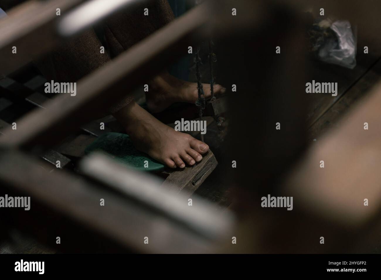Bangkok, Thailand. 17th May, 2021. Weaver's feet step on the pedals of ...