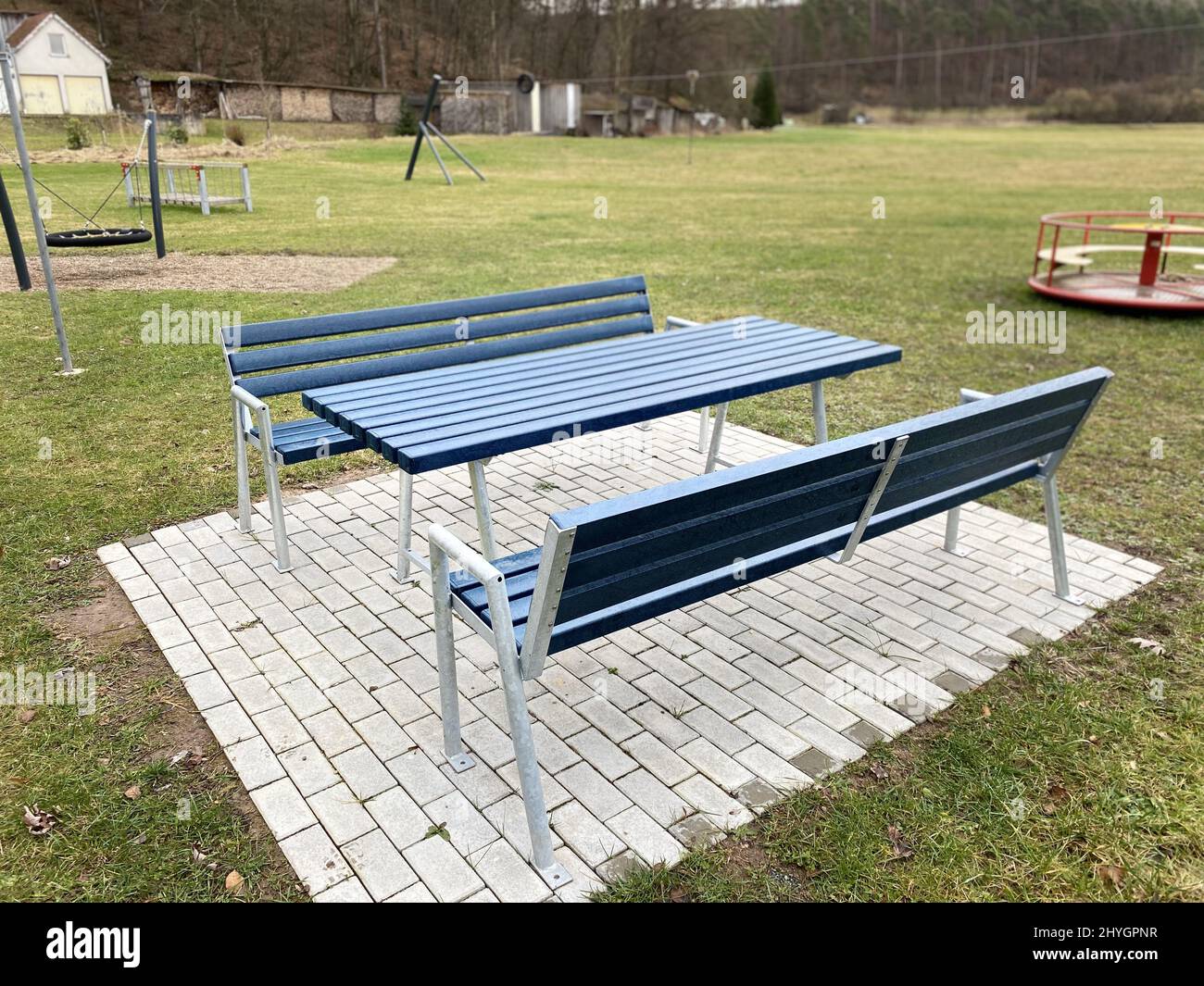 Table with benches in the playground Stock Photo - Alamy