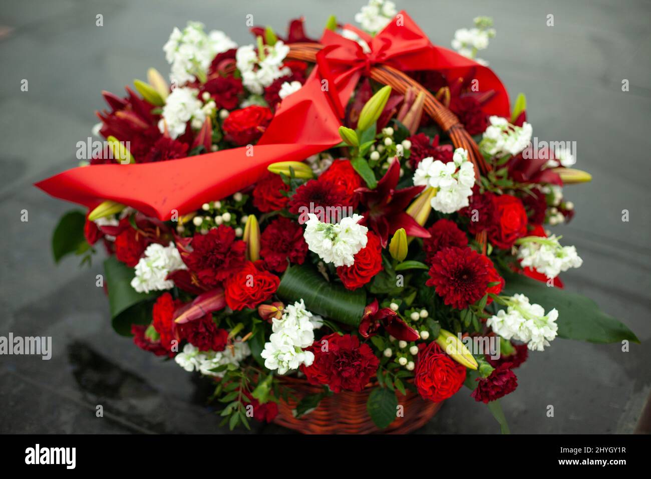 Flowers on monument. Artificial flowers on memorial. Solemn wreath on ...