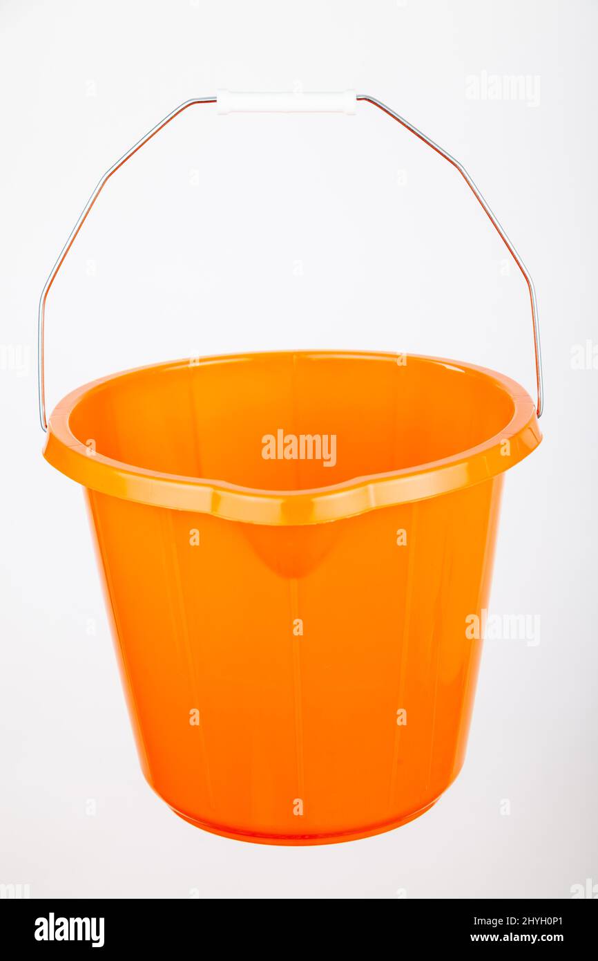 Orange plastic bucket on white background Stock Photo - Alamy