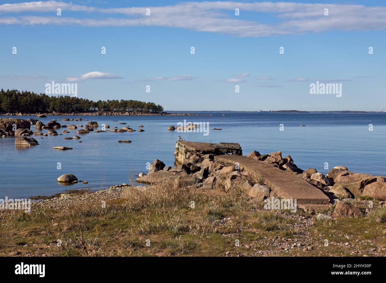 Old concrete pier on a rocky seashore on the island of Kaunissaari ...
