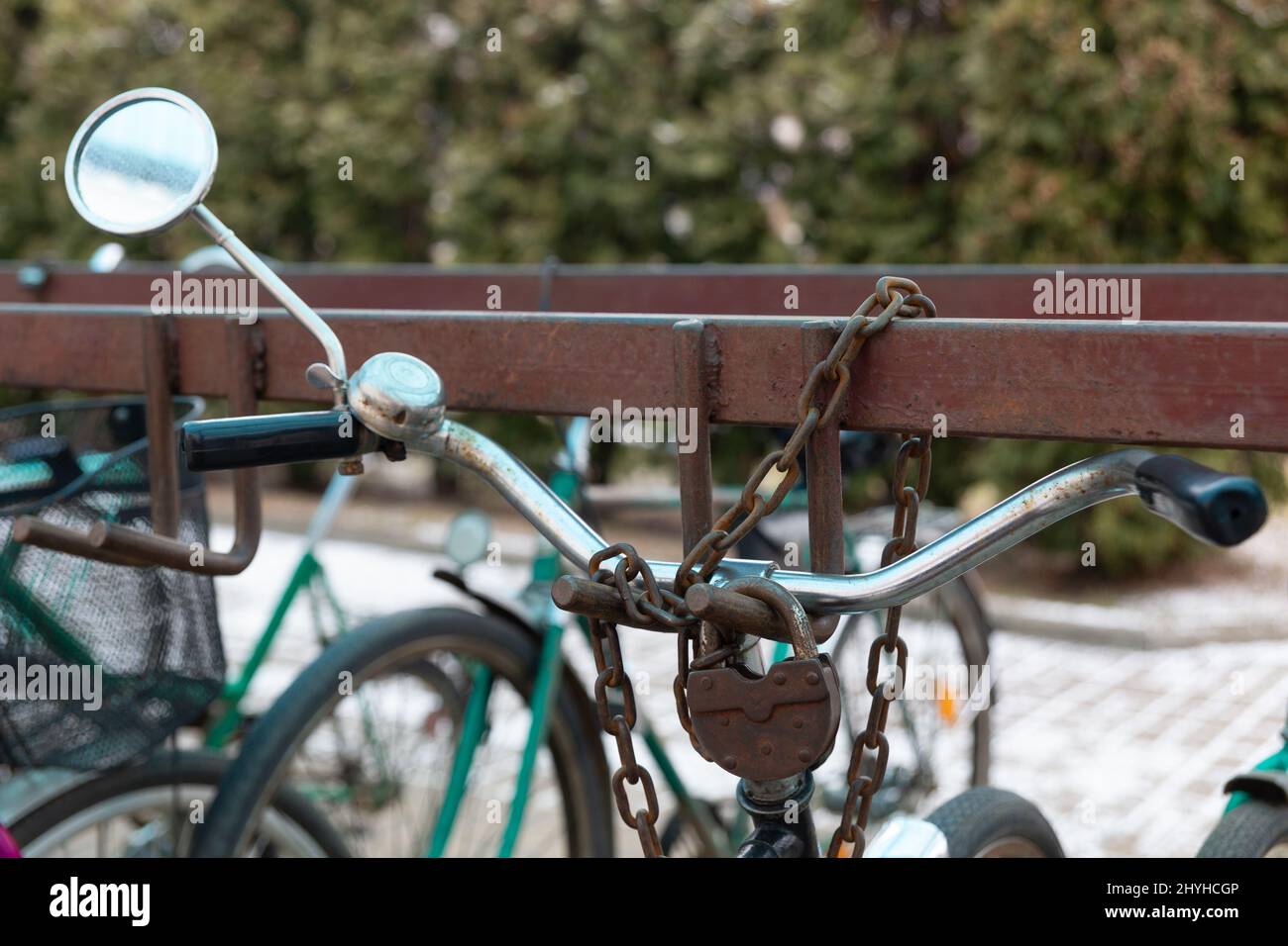 Bicycle chained to a parking. Lock and chain on bicycle handlebar ...