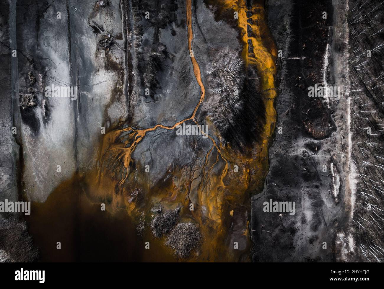 Aerial view of a desolate landscape with the delta of a soiled water ...
