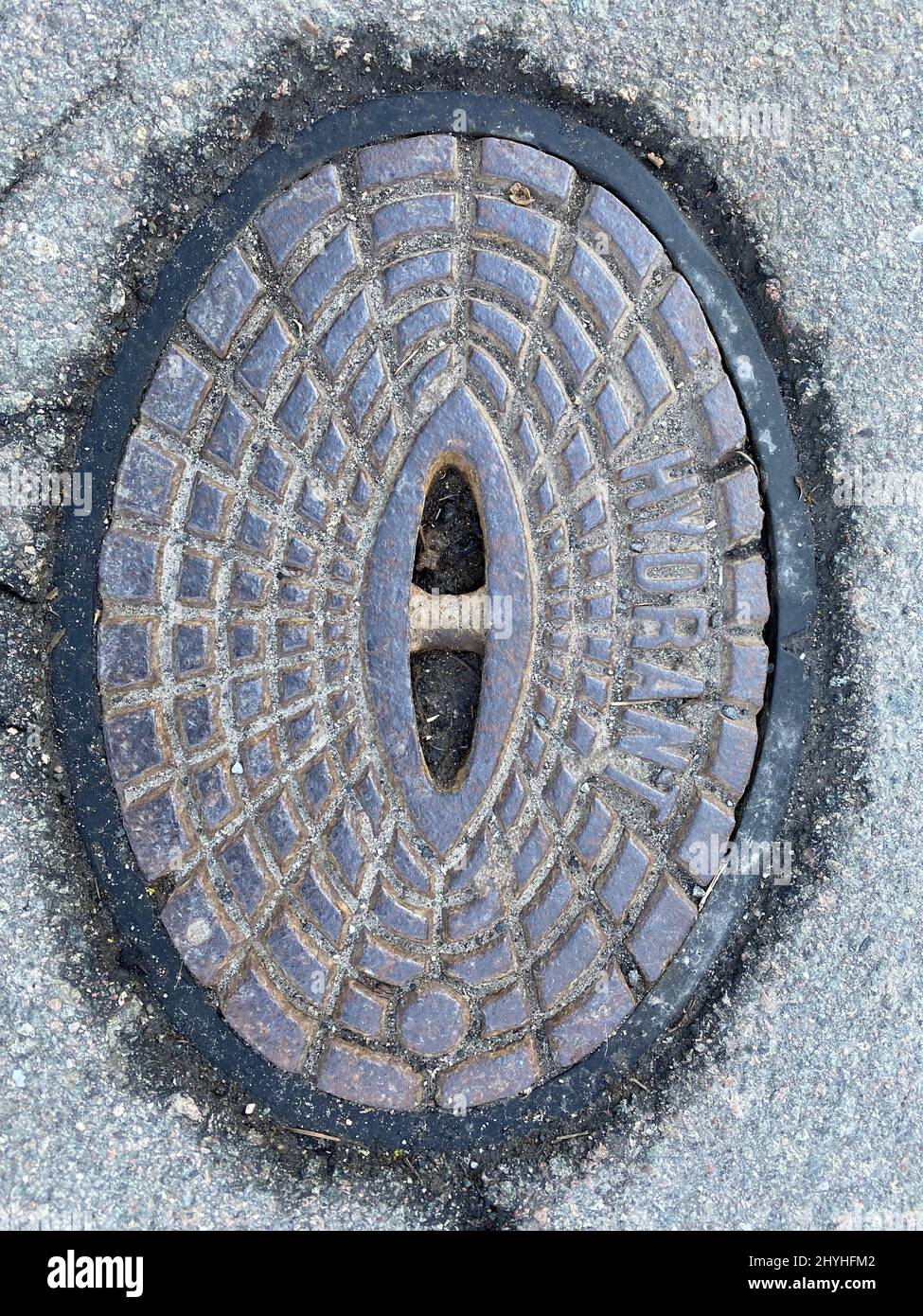 Vertical top view of an old metal manhole Stock Photo - Alamy