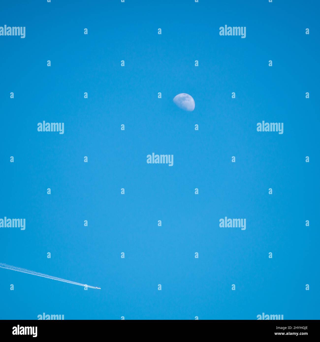 An airplane flies under the crescent moon Stock Photo - Alamy
