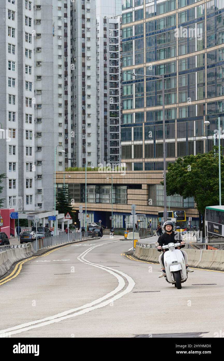 Vertical shot of a view of a street in Hong Kong with tall buildings ...