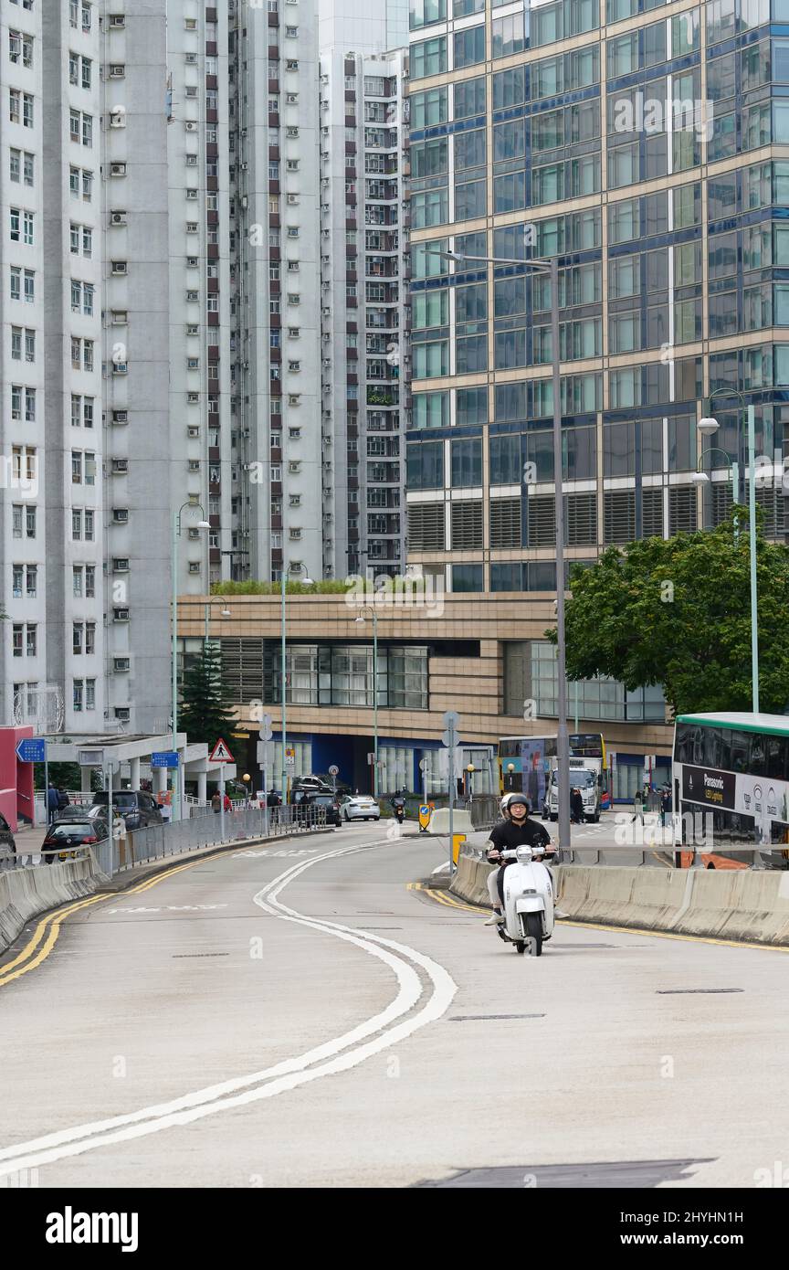 Vertical shot of a view of a street in Hong Kong with tall buildings ...