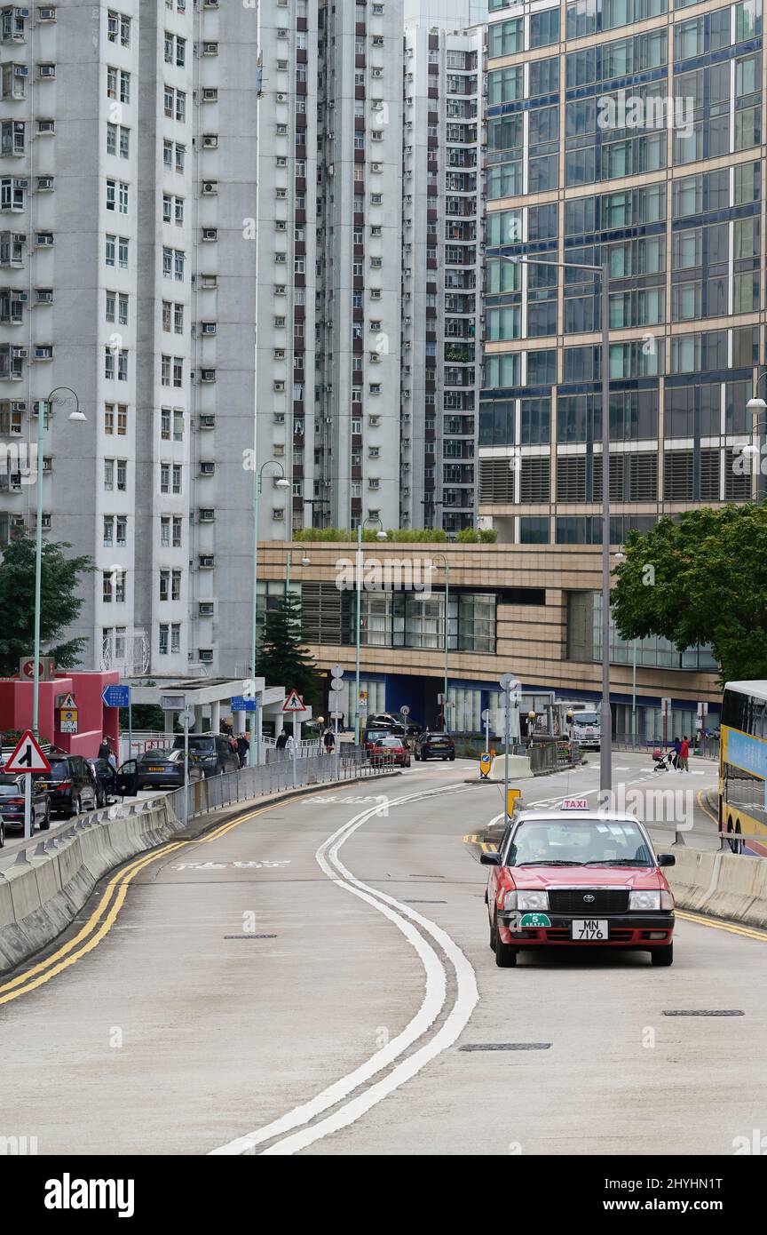 Vertical shot of a view of a street in Hong Kong with tall buildings ...