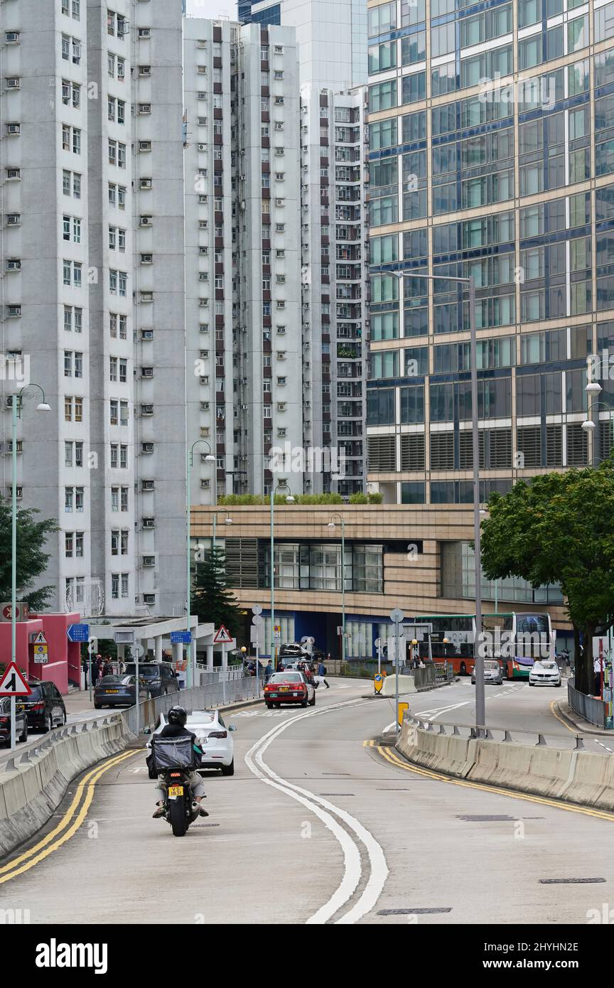 Vertical shot of a view of a street in Hong Kong with tall buildings ...