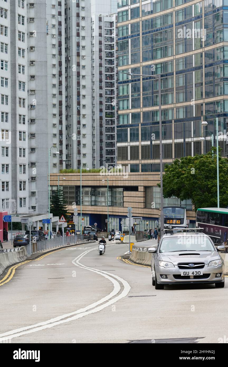 Vertical shot of a view of a street in Hong Kong with tall buildings ...