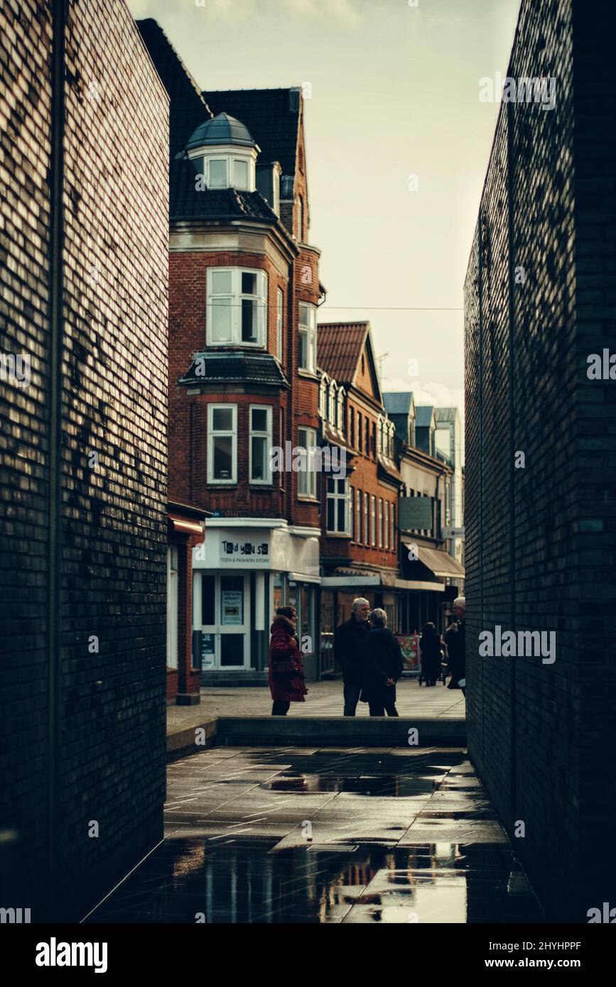Vertical shot of people having a conversation in the marketplace in ...