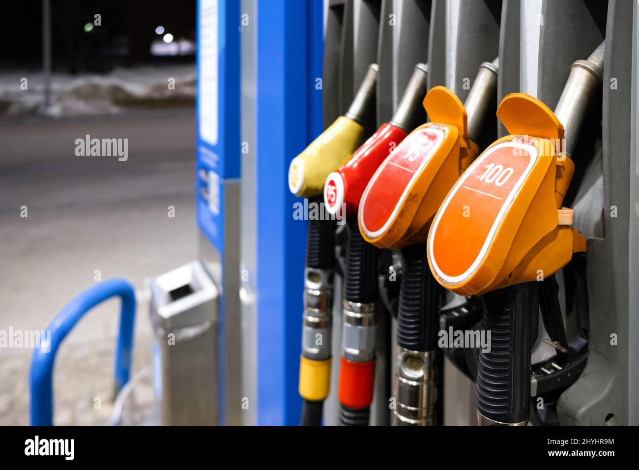 Close-up of a fuel pump pistol grip at a gas station. Selective focus ...