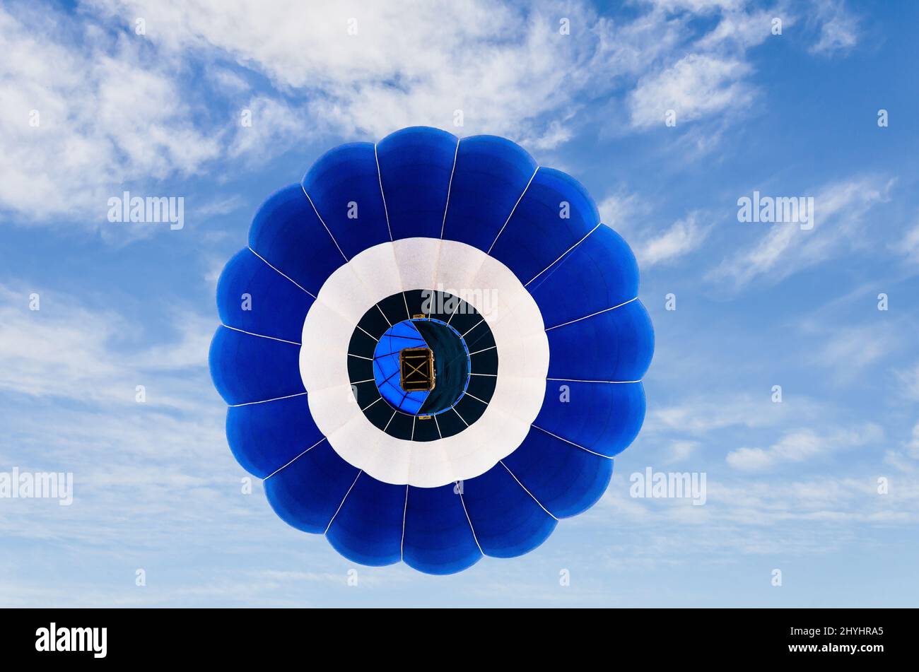 Blue hot air balloon flying in the sky from under Stock Photo - Alamy
