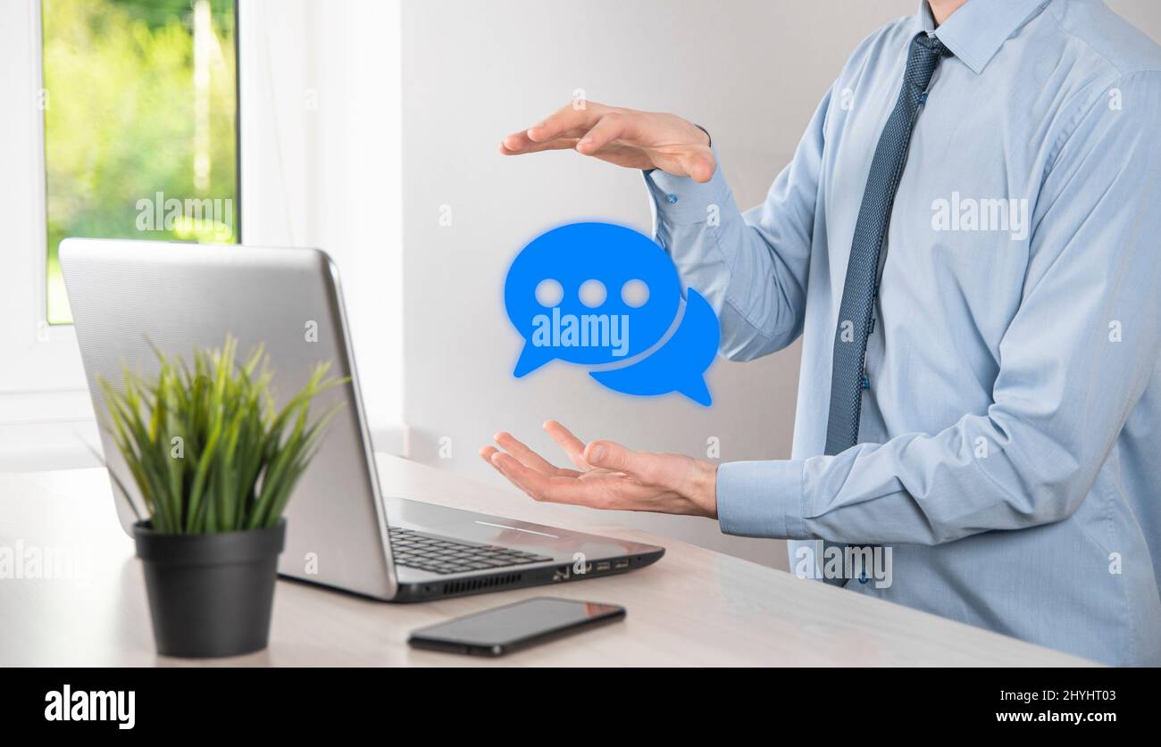 Businessman holding a message icon, bubble talk notification sign in ...