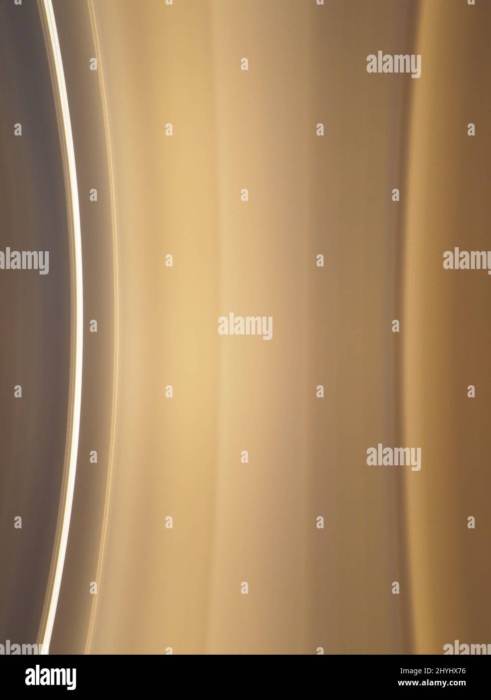 Abstract yellow flow vertical background. Blurry golden flow in a ...