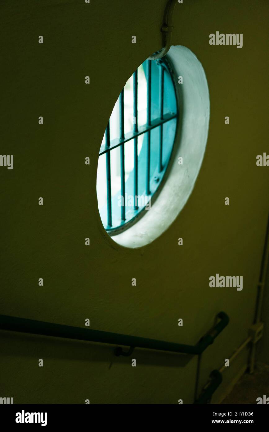 Vertical photo of a circular window of a building taken from inside ...