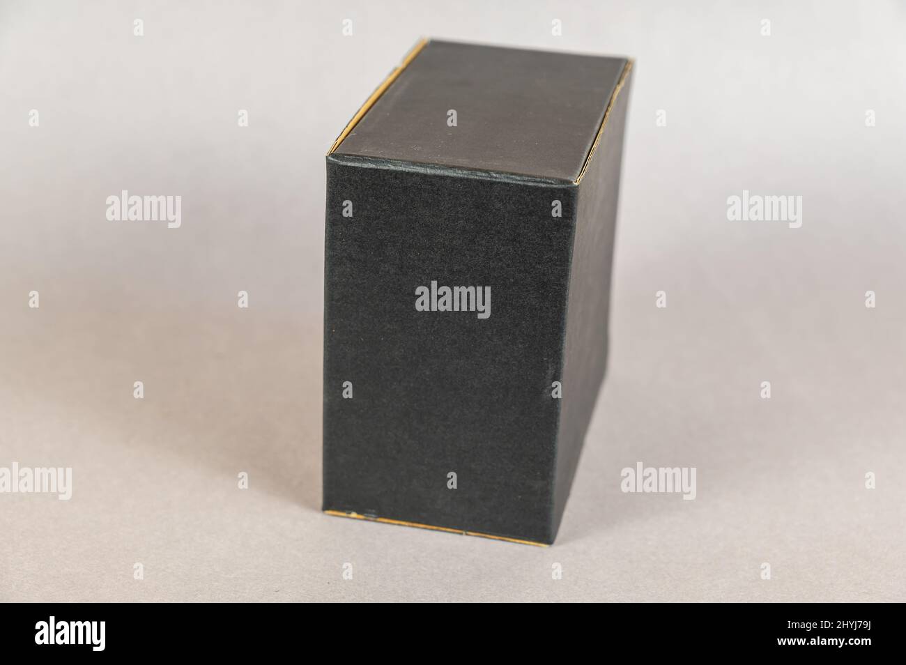 Rectangular black box on a gray background. Closed cardboard package ...
