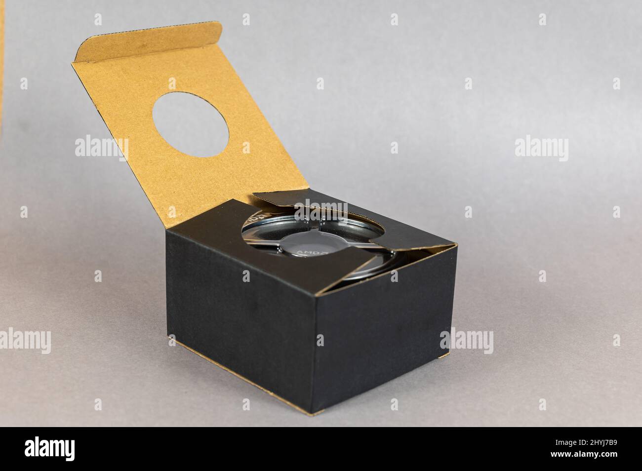 New AMD CPU cooler is in black cardboard box. Advanced Micro Devices ...
