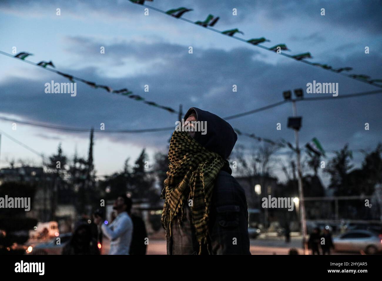 Idlib, Syria. 14th Mar, 2022. A man looks at a flag pole ahead of the ...