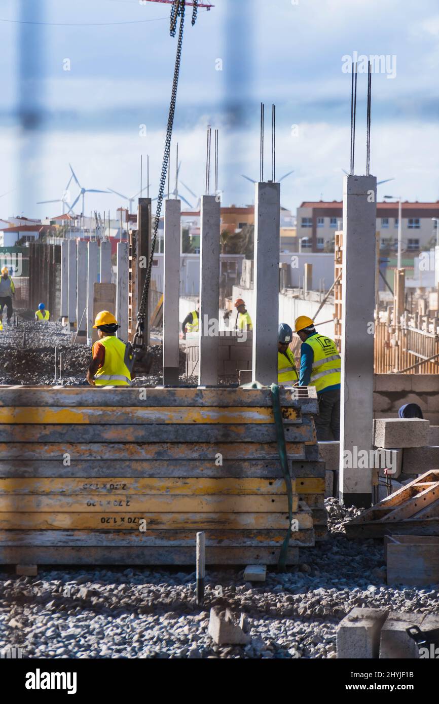 Photo of workers working on a construction settlement in the street ...