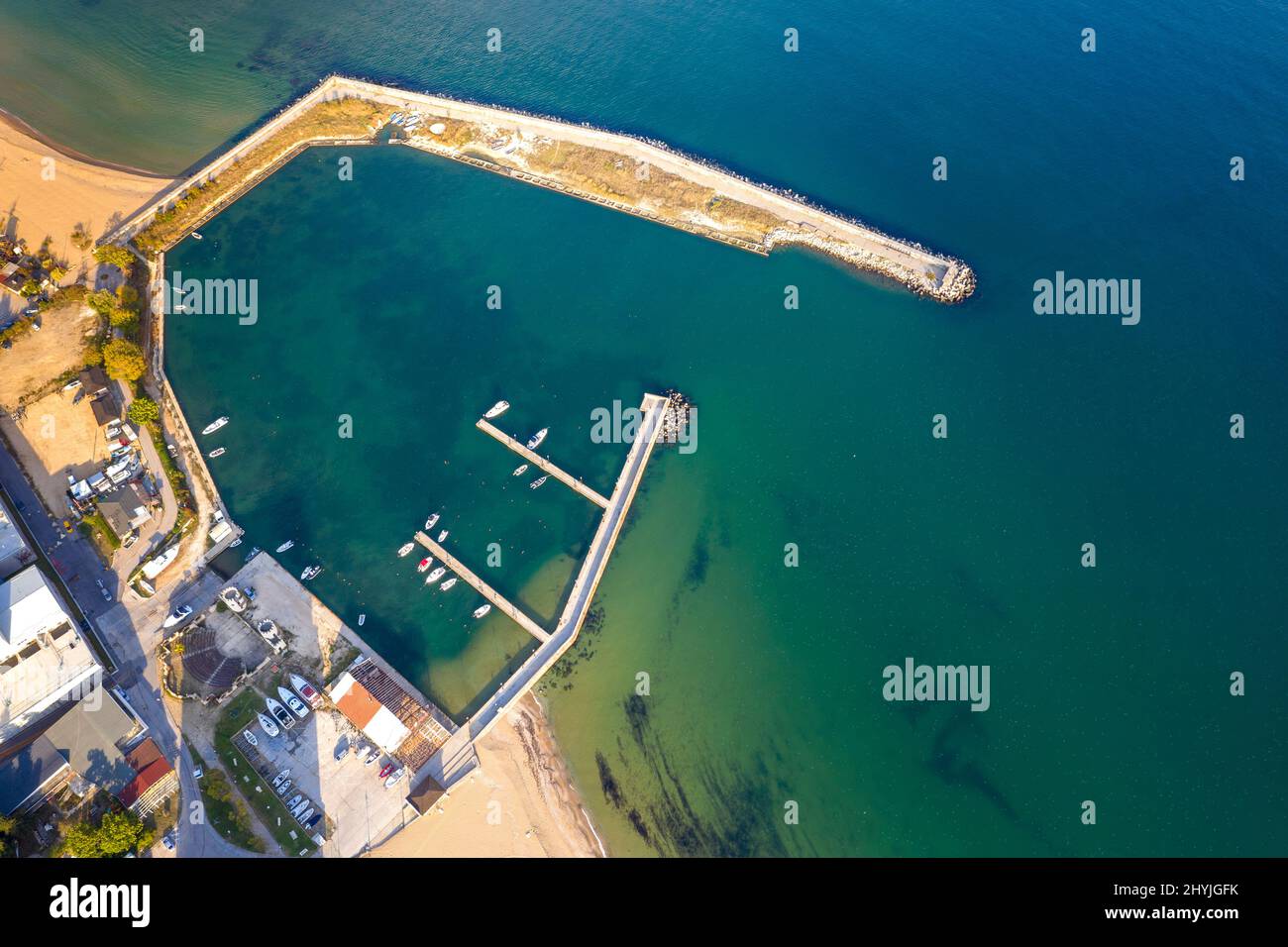 Aerial top view from drone to the seacoast and small marina with boats ...