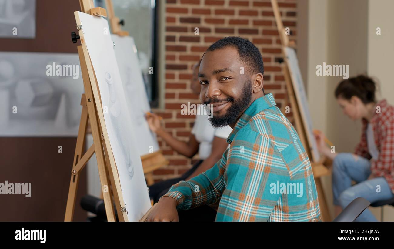 Portrait of young man drawing inspiration object in art class using ...