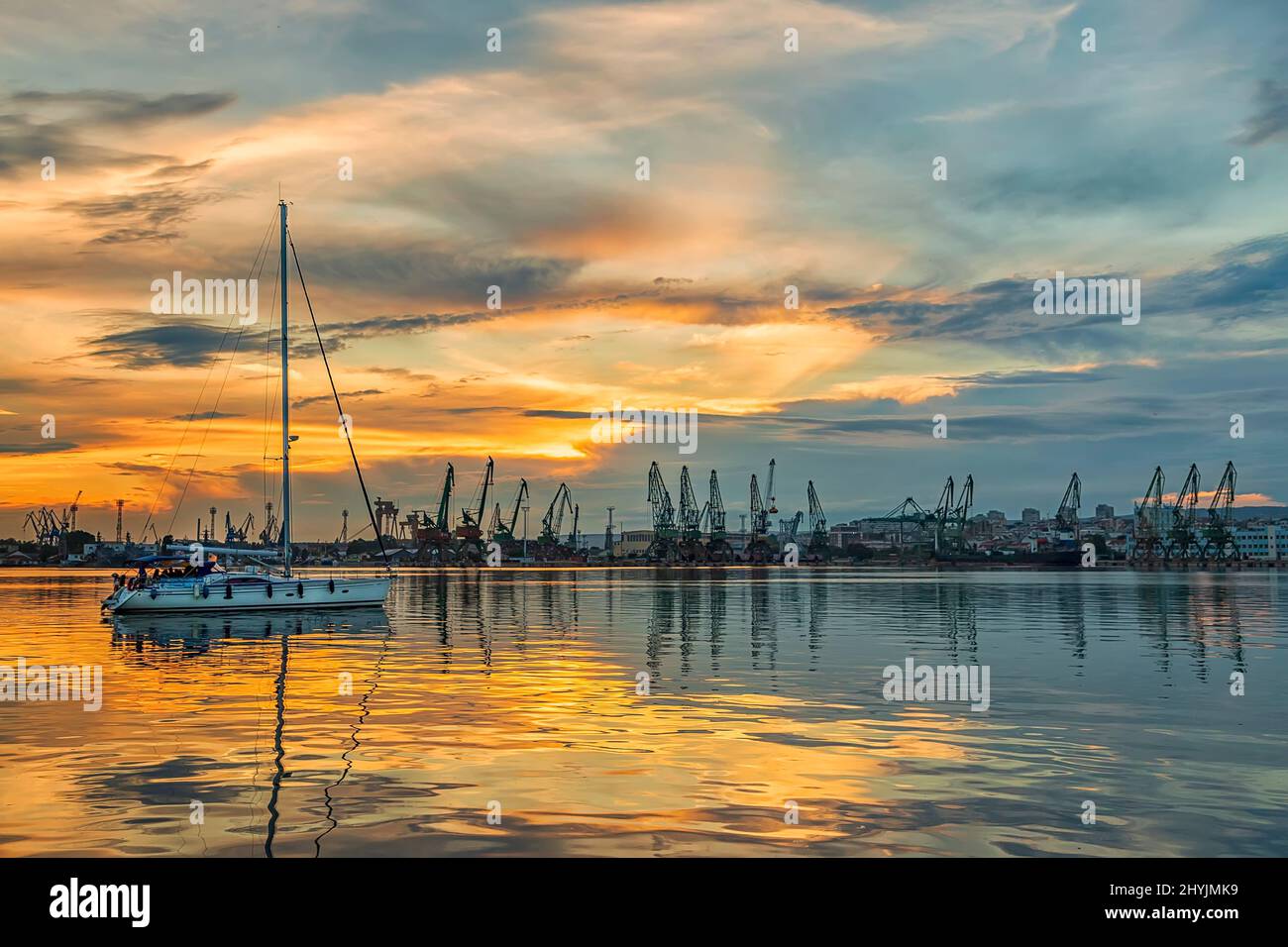 Yacht coming a port at a stunning sunset Stock Photo - Alamy