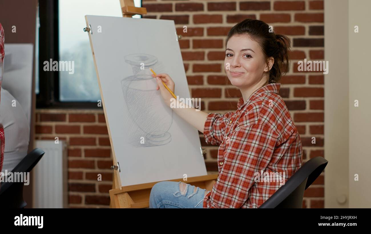 Portrait of creative woman attending art class program to draw ...