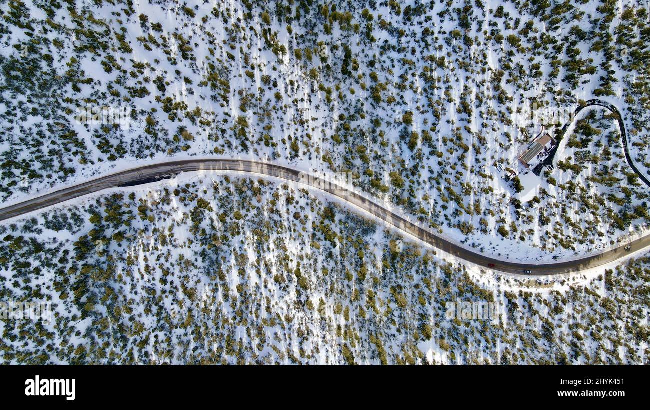 Aerial view of a beautiful winter landscape with a road and trees ...