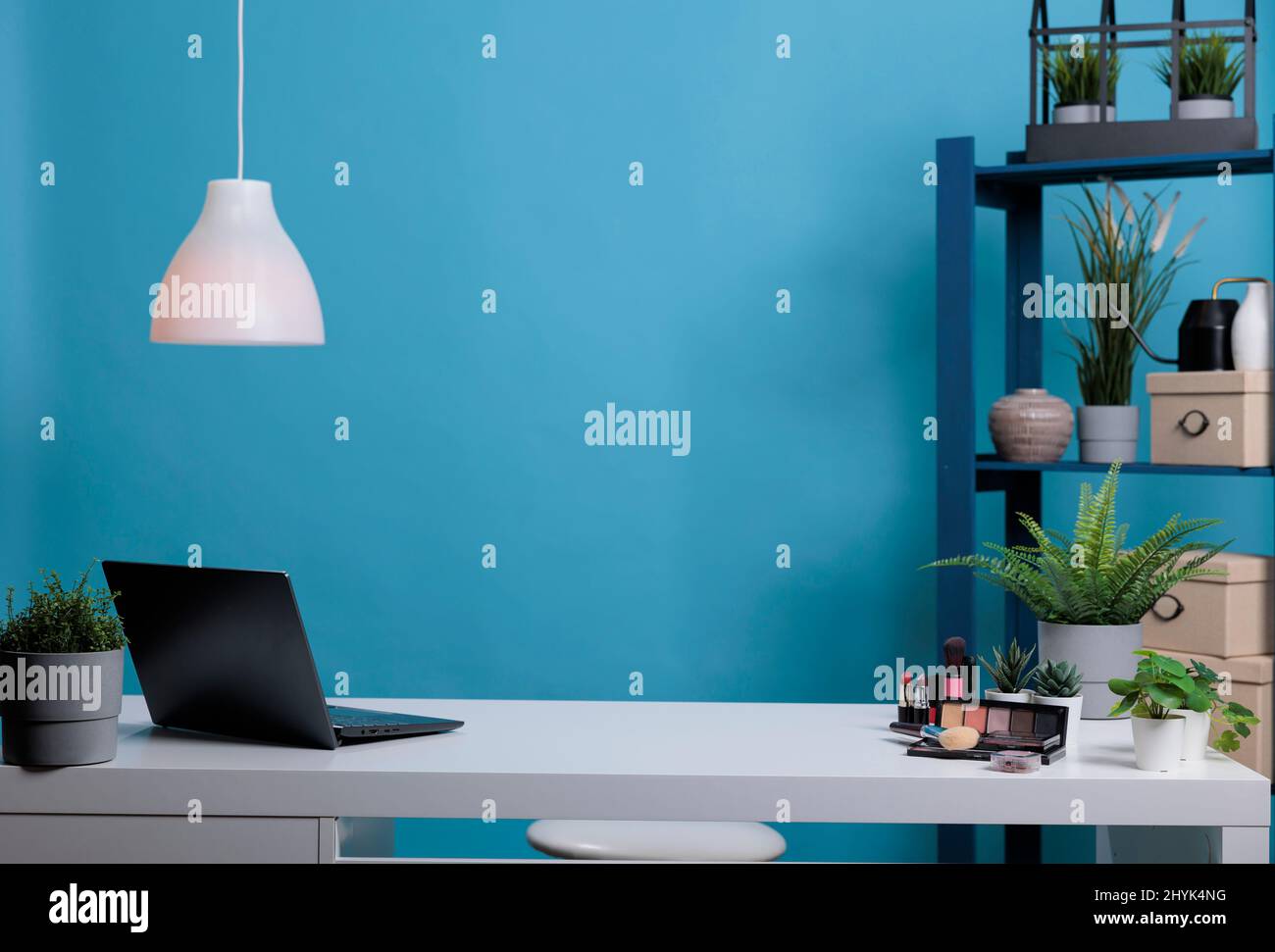 Empty studio with blue background ready for podcast recording. Makeup ...