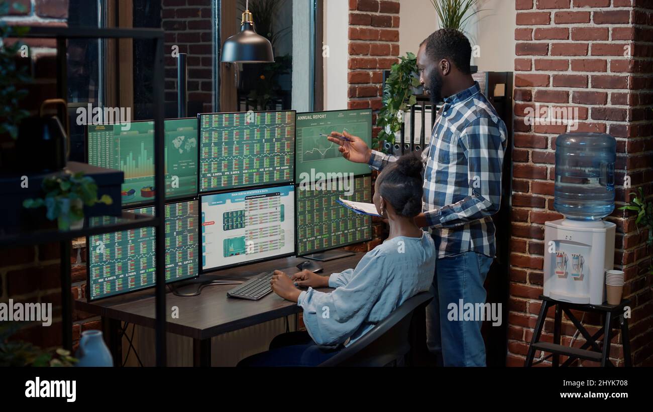 Work colleagues brainstorming ideas to sell trade stocks from stock ...