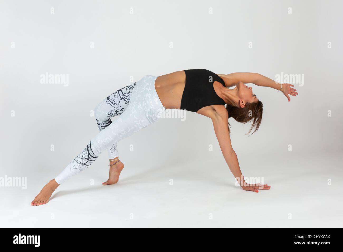 Young girl doing exercise on isolated white background Stock Photo - Alamy