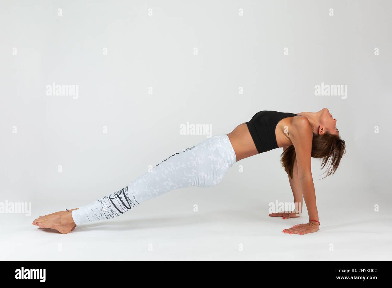 Young girl doing exercise on isolated white background Stock Photo - Alamy
