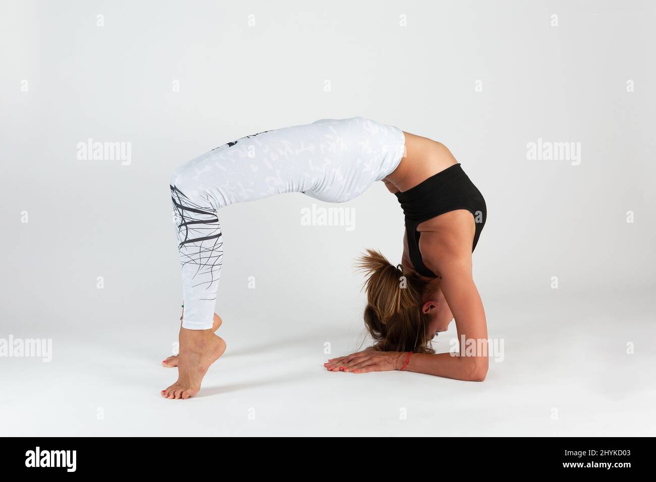 Young girl doing exercise on isolated white background Stock Photo - Alamy