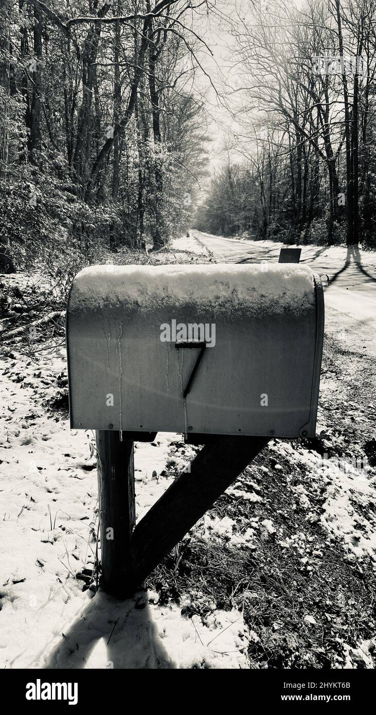 Vertical grayscale closeup of the metal mailbox with number seven ...