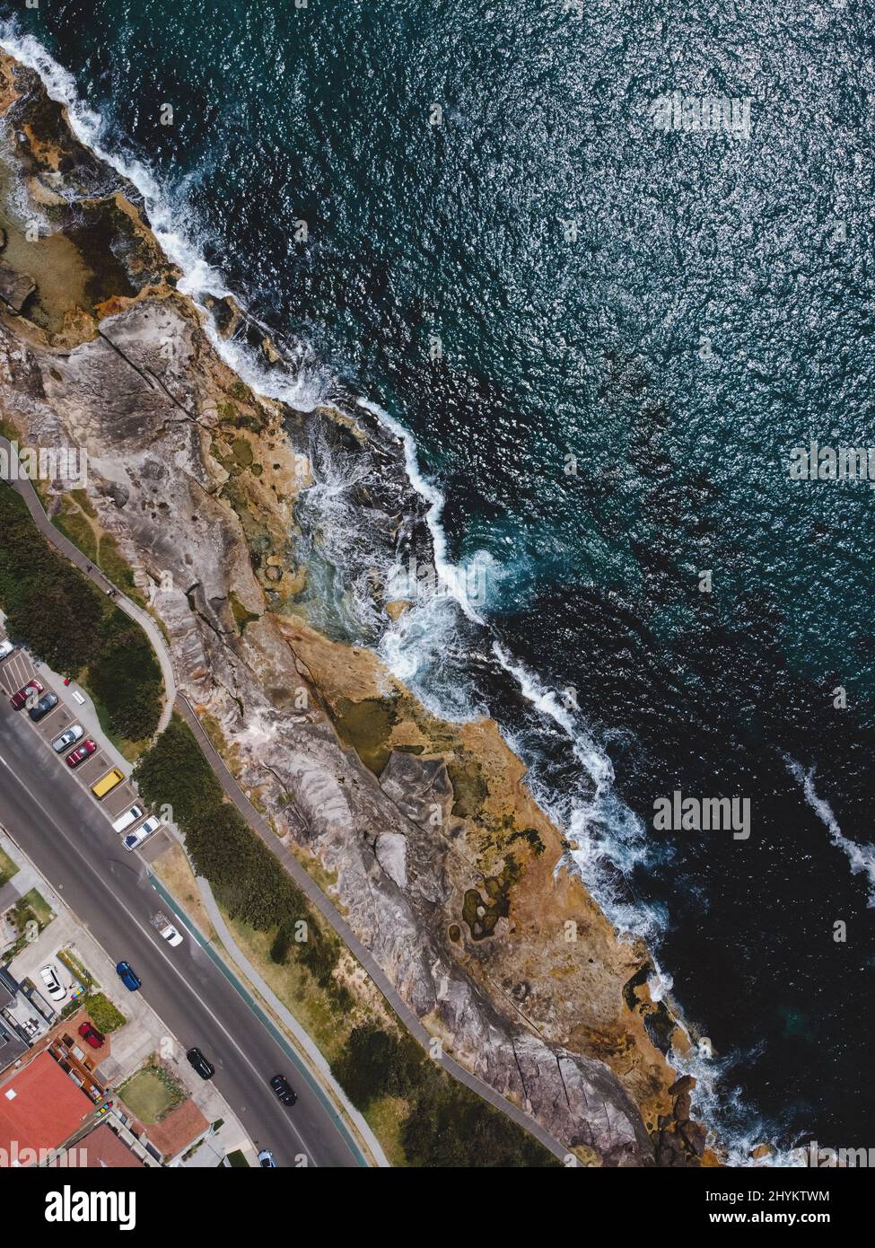 Vertical bird's eye view of the shoreline and the blue water surface ...
