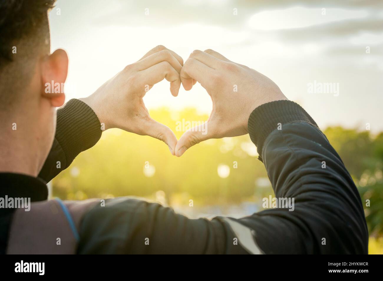 Close up of two hands together in a heart shape, hands together in a ...