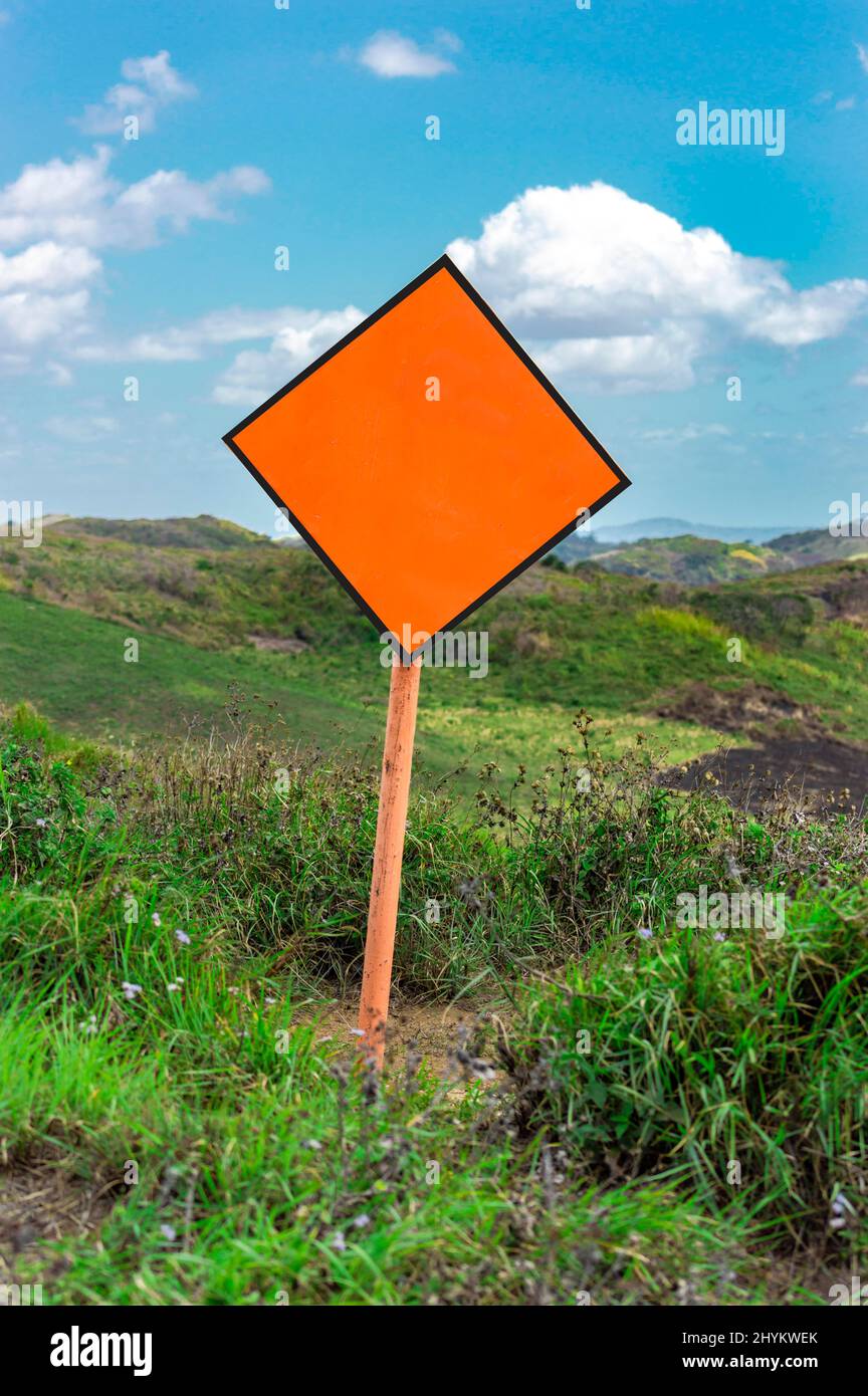 An empty sign on top of a hill, empty sign surrounded by vegetation ...
